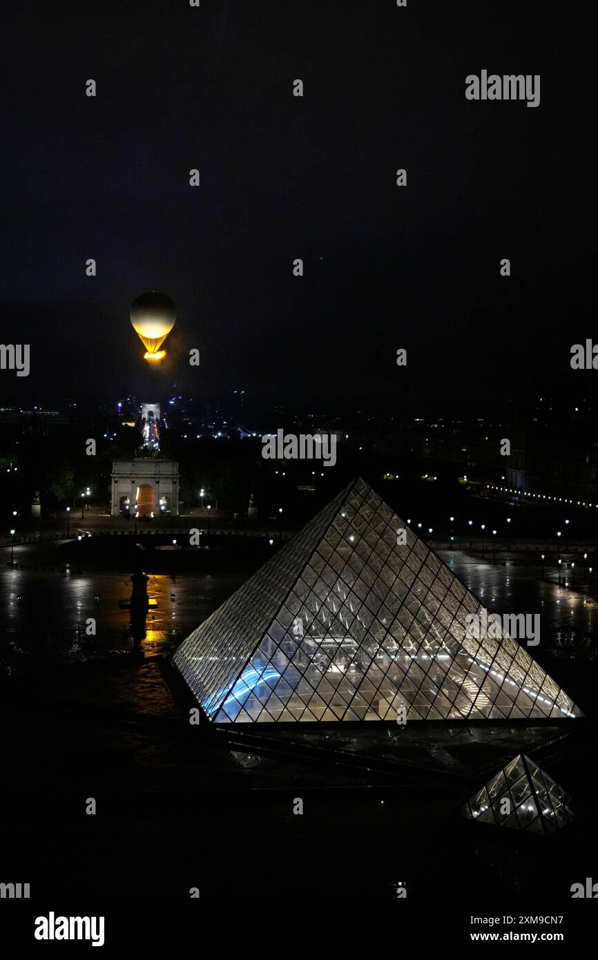 The cauldron, with the Olympic flame lit, lifts off while attached to a ...