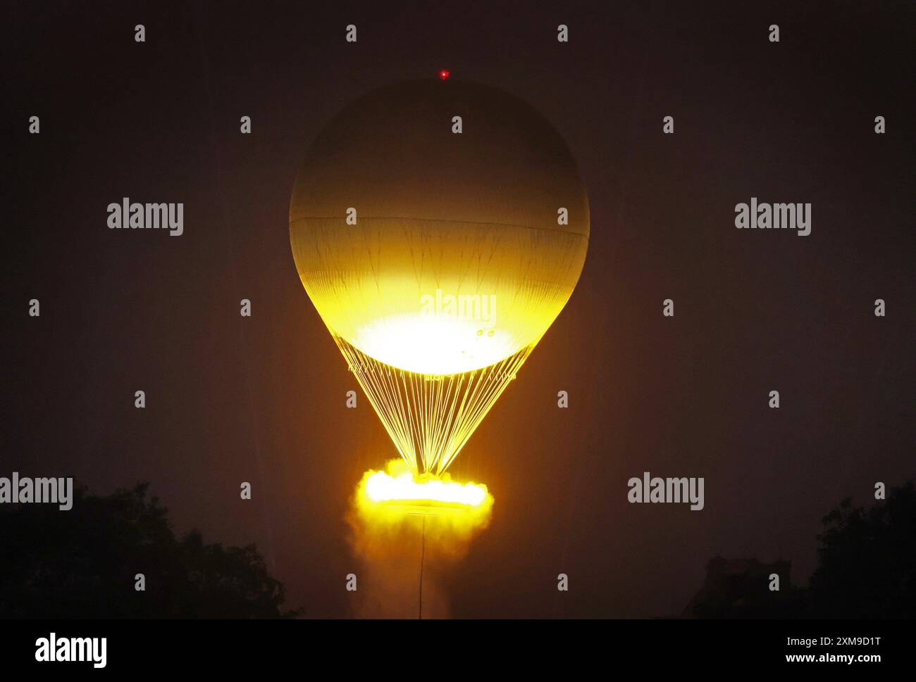 Paris, France. 26th July, 2024. A hot air balloon carrying the Olympic ...