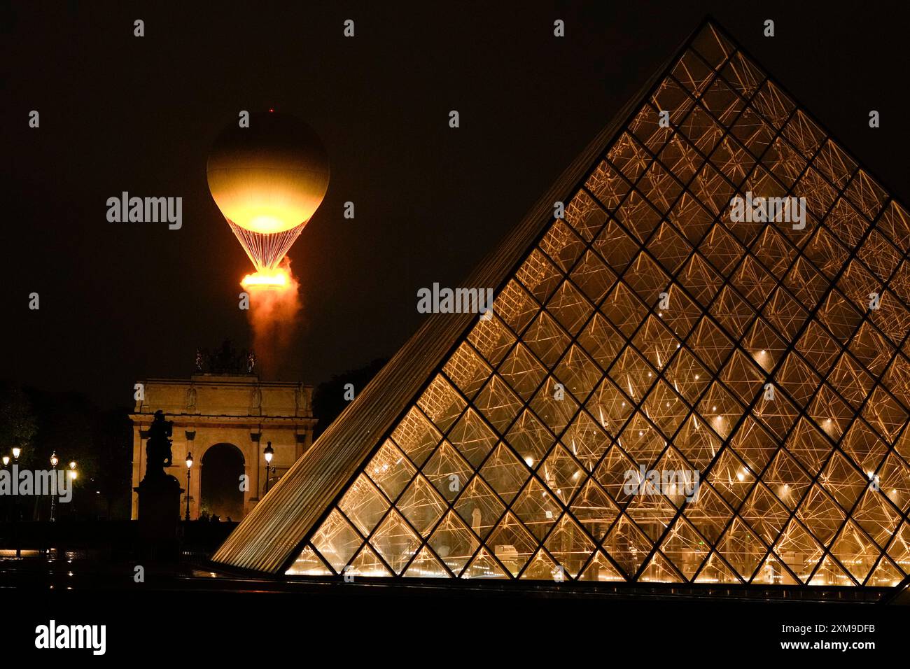 The Olympic Flame rises on a balloon after being lit in Paris, France ...