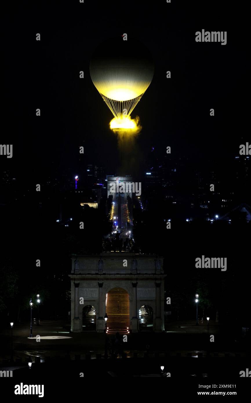 A balloon carrying the Olympic Cauldron rises to conclude the opening ...