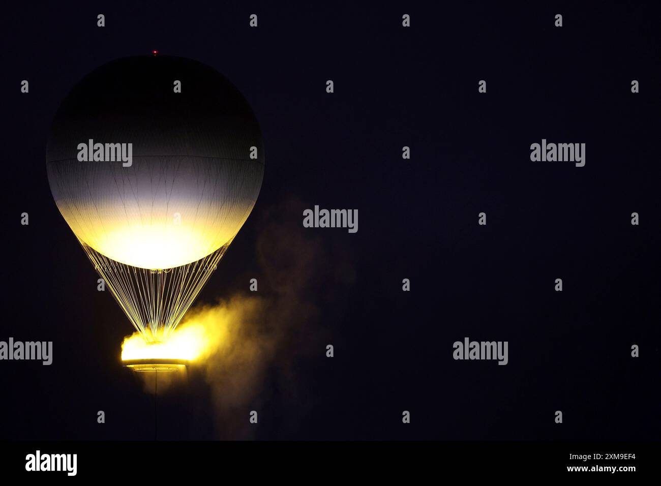 A balloon carrying the Olympic Cauldron rises in the sky during the ...