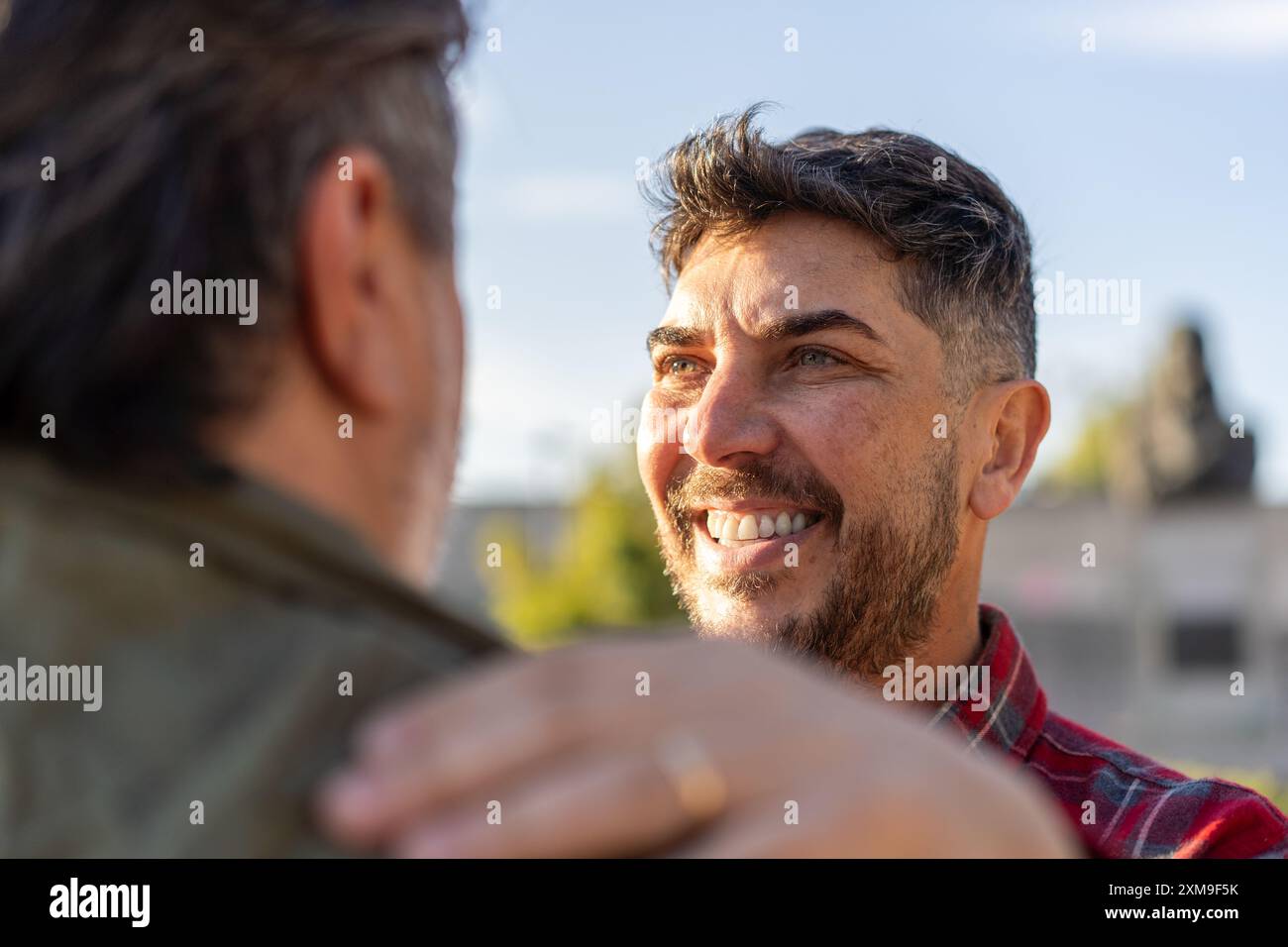 Happy gay couple cuddling hi-res stock photography and images - Alamy