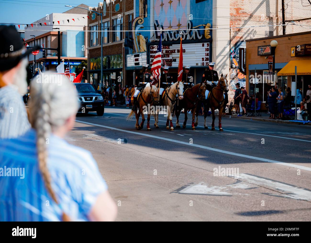 Audience members place their hands over their hearts as U.S. Marines ...