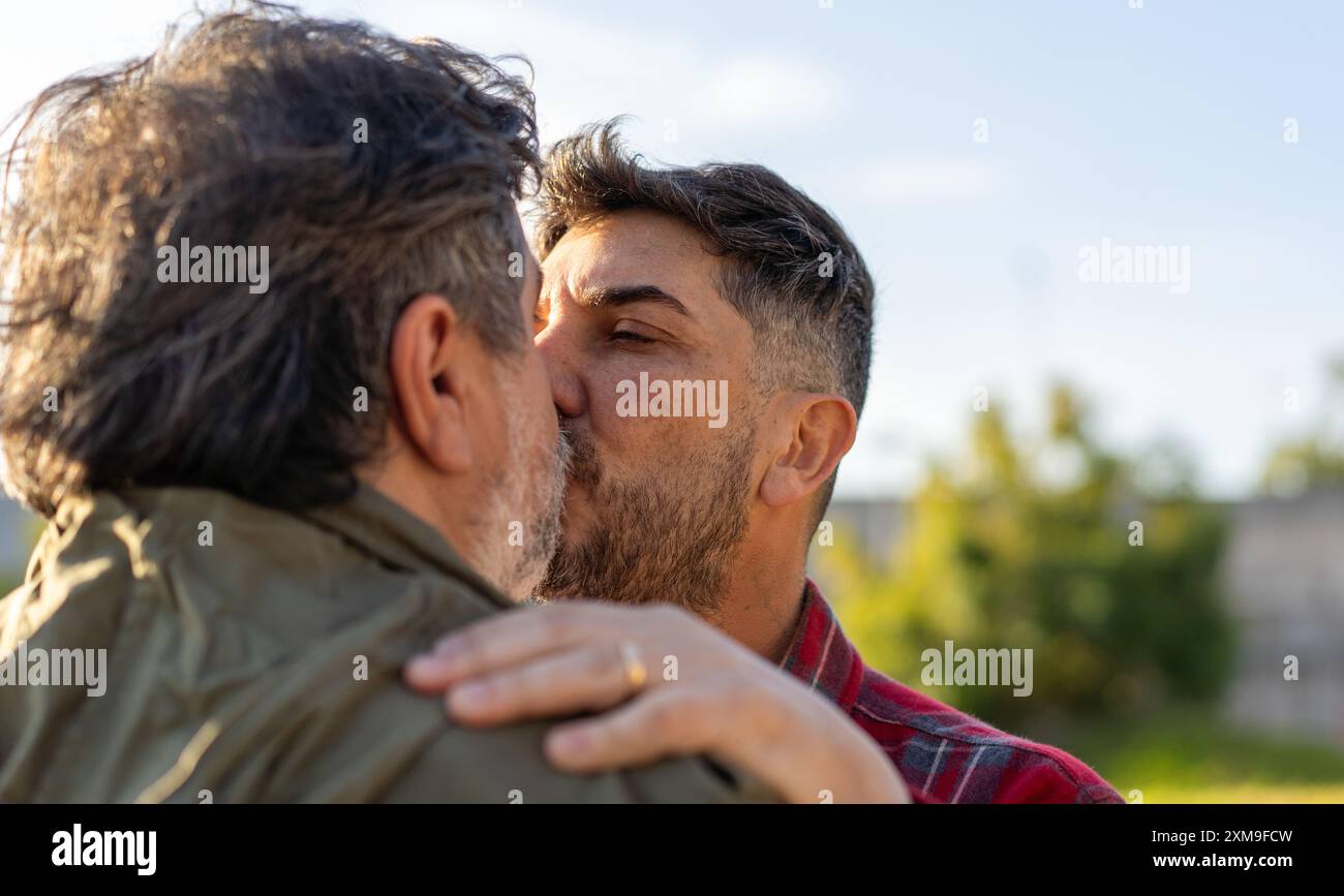 Gay male couple kissing hi-res stock photography and images - Alamy