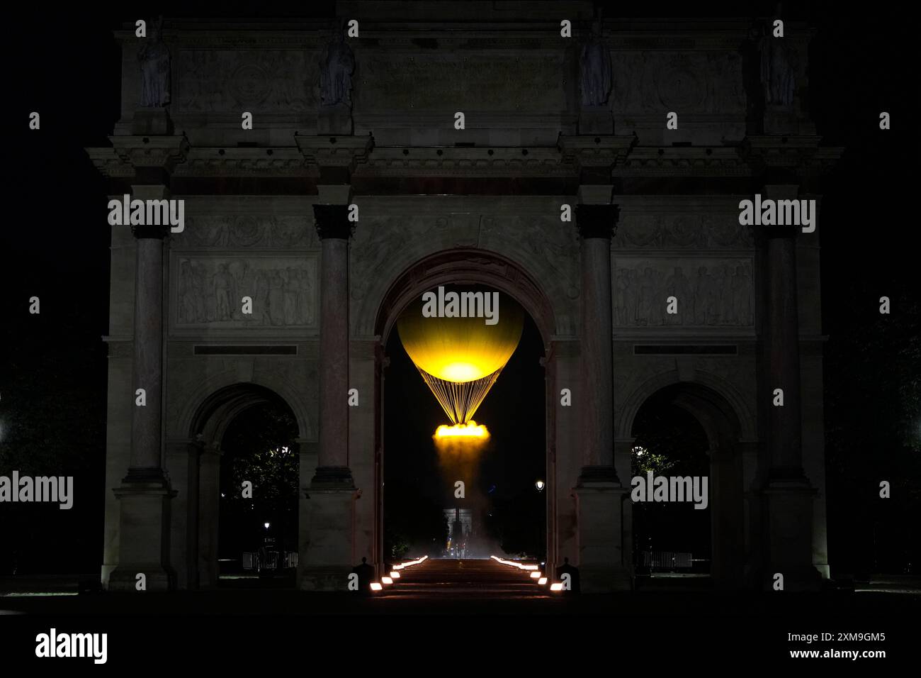 The cauldron rises in a balloon seen through the Carrousel du Louvre in ...