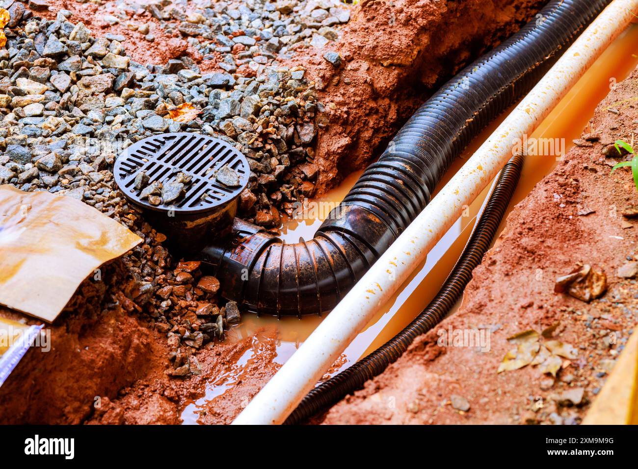 Drainage trench used for communications cables is inundated with water ...
