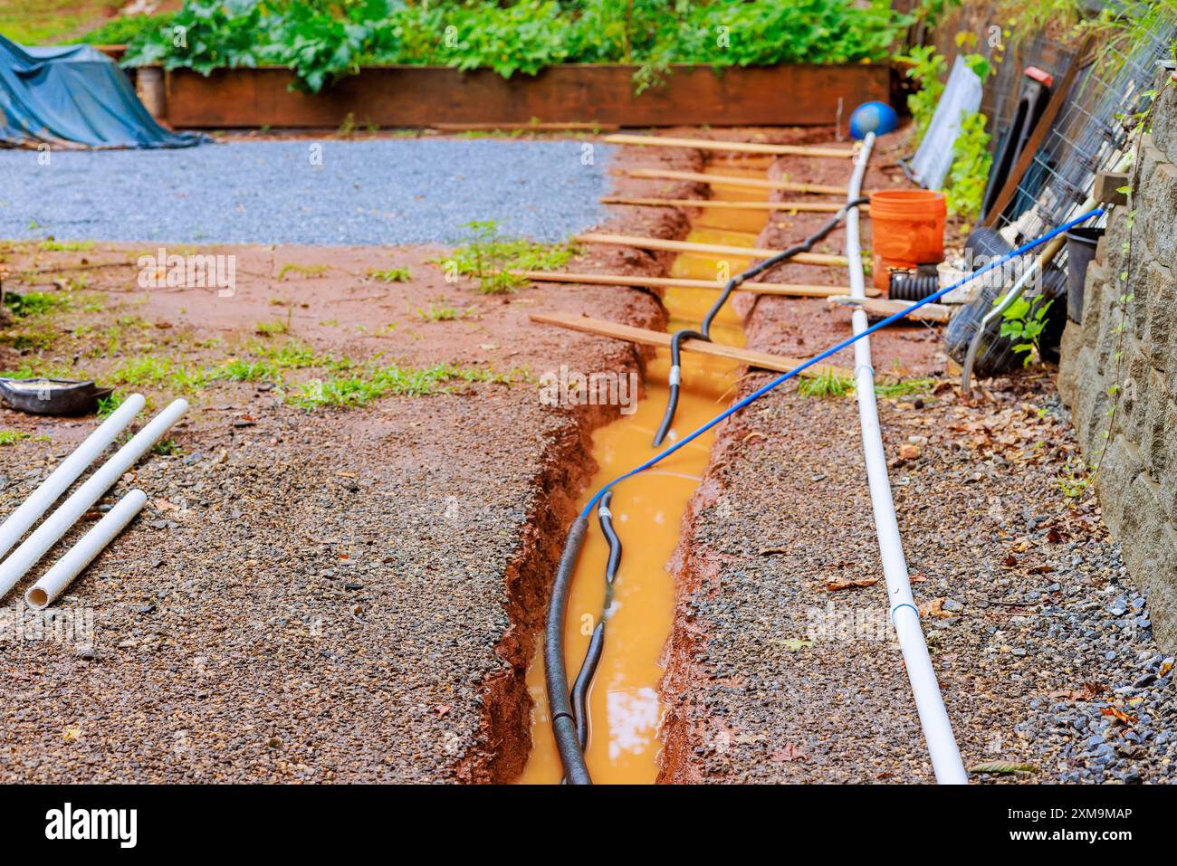 Water floods drainage trench used for communication cables during heavy ...