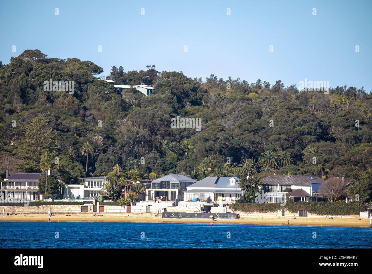 Camp Cove beach on Sydney Harbour, with luxury harbour front beach side ...