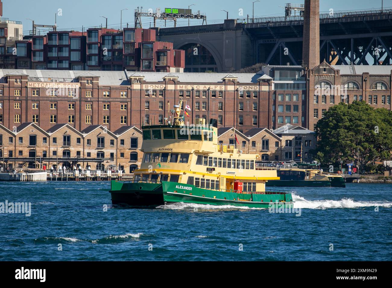Sydney ferry Alexander on Sydney harbour with The Rocks precinct and ...