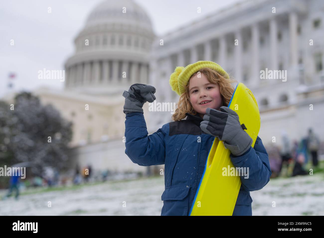 Kids play with snowboard in winter park. First Winter snow. Kids ...