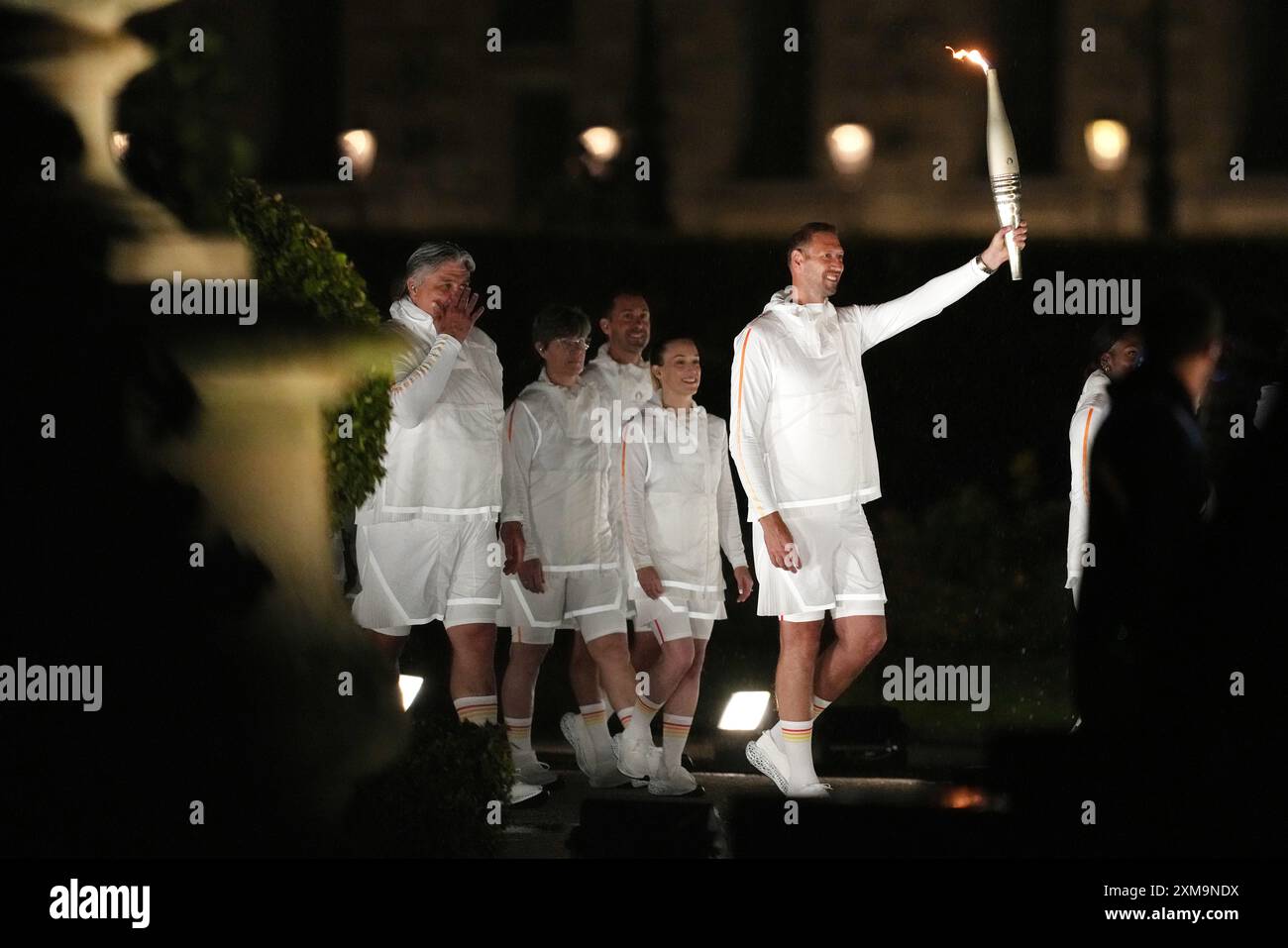 Paris, France. 26th July, 2024. Torch bearers attend the torch relay ...