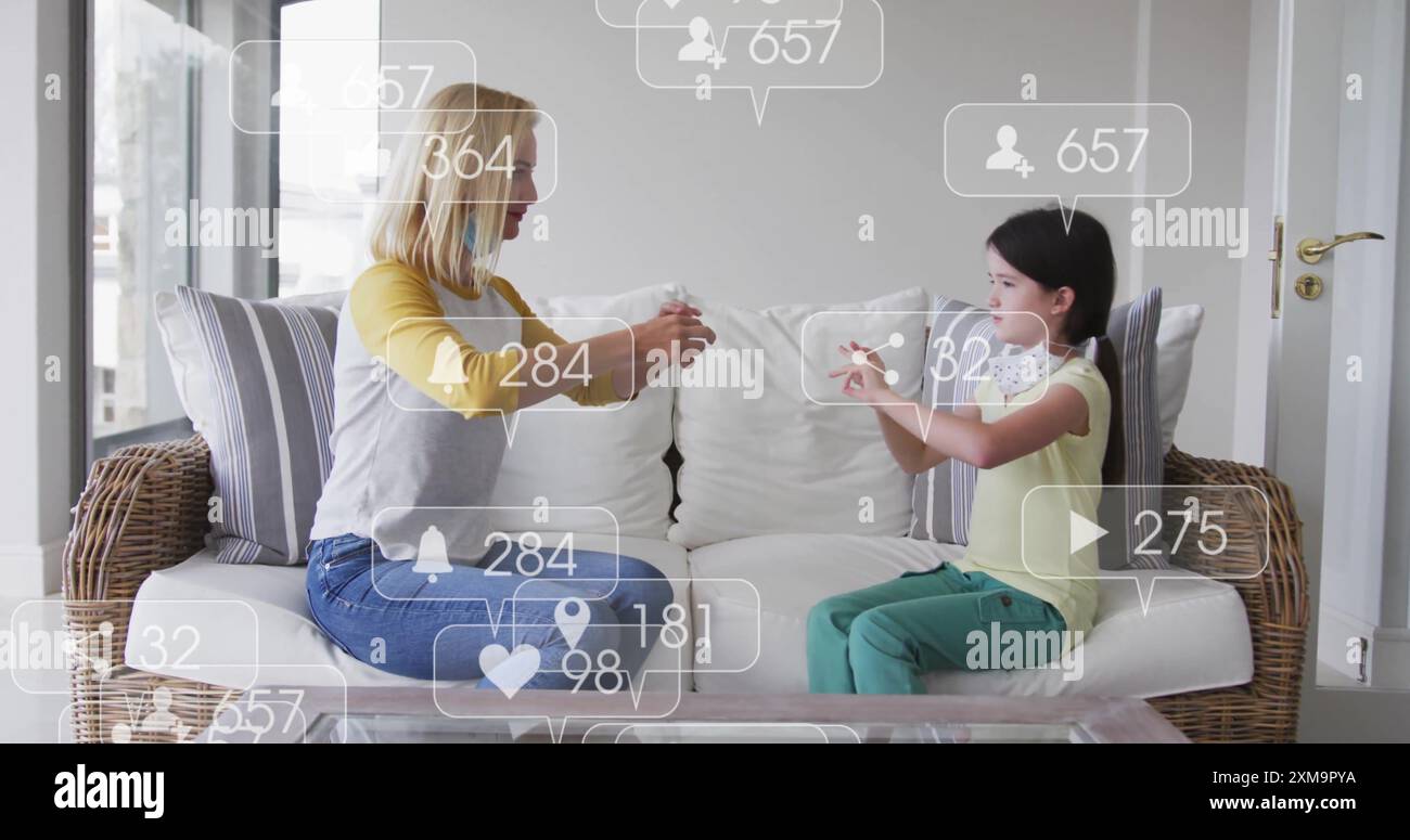 Social media interaction icons image over woman and child playing hand ...