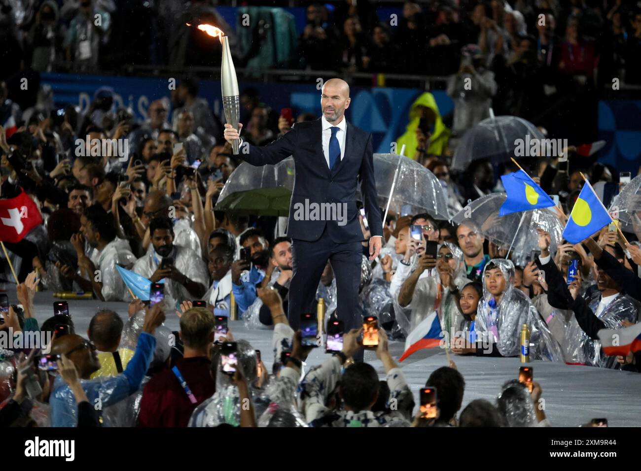 Paris, France. 26th July, 2024. Zinedine Zidane holds the Olympic torch ...