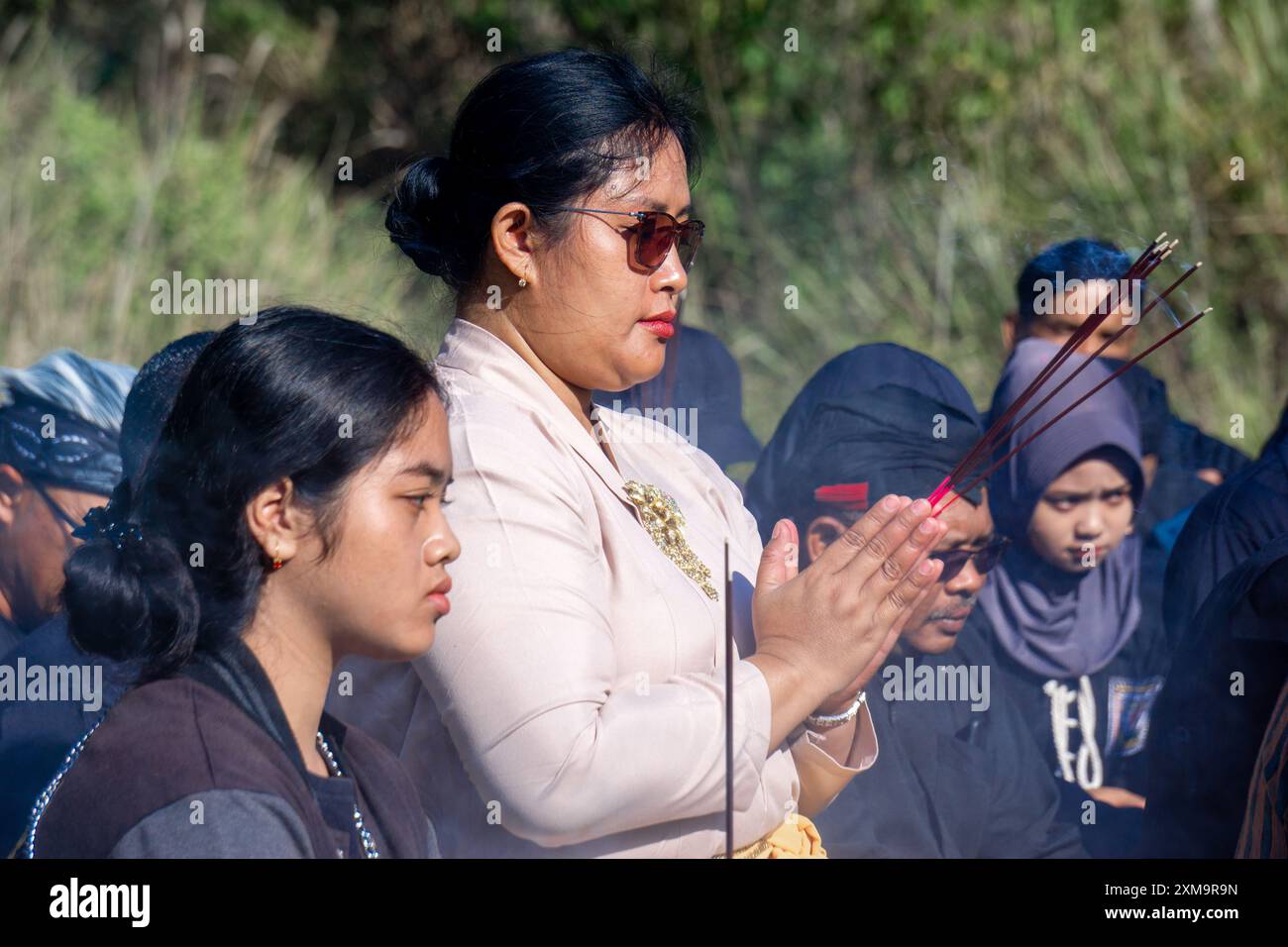 Javanese people pray during the Larungan ceremony on Mount Kelud Stock ...
