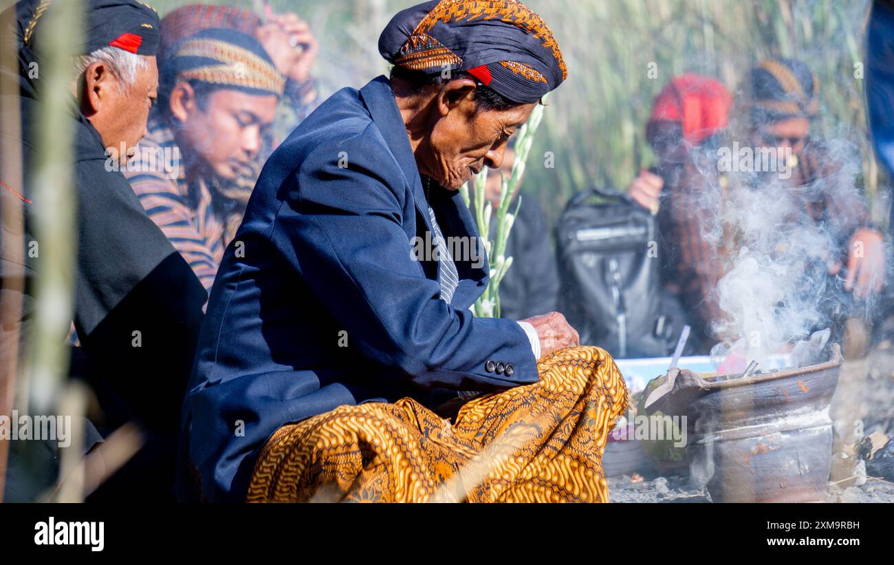 Javanese people pray during the Larungan ceremony on Mount Kelud Stock ...