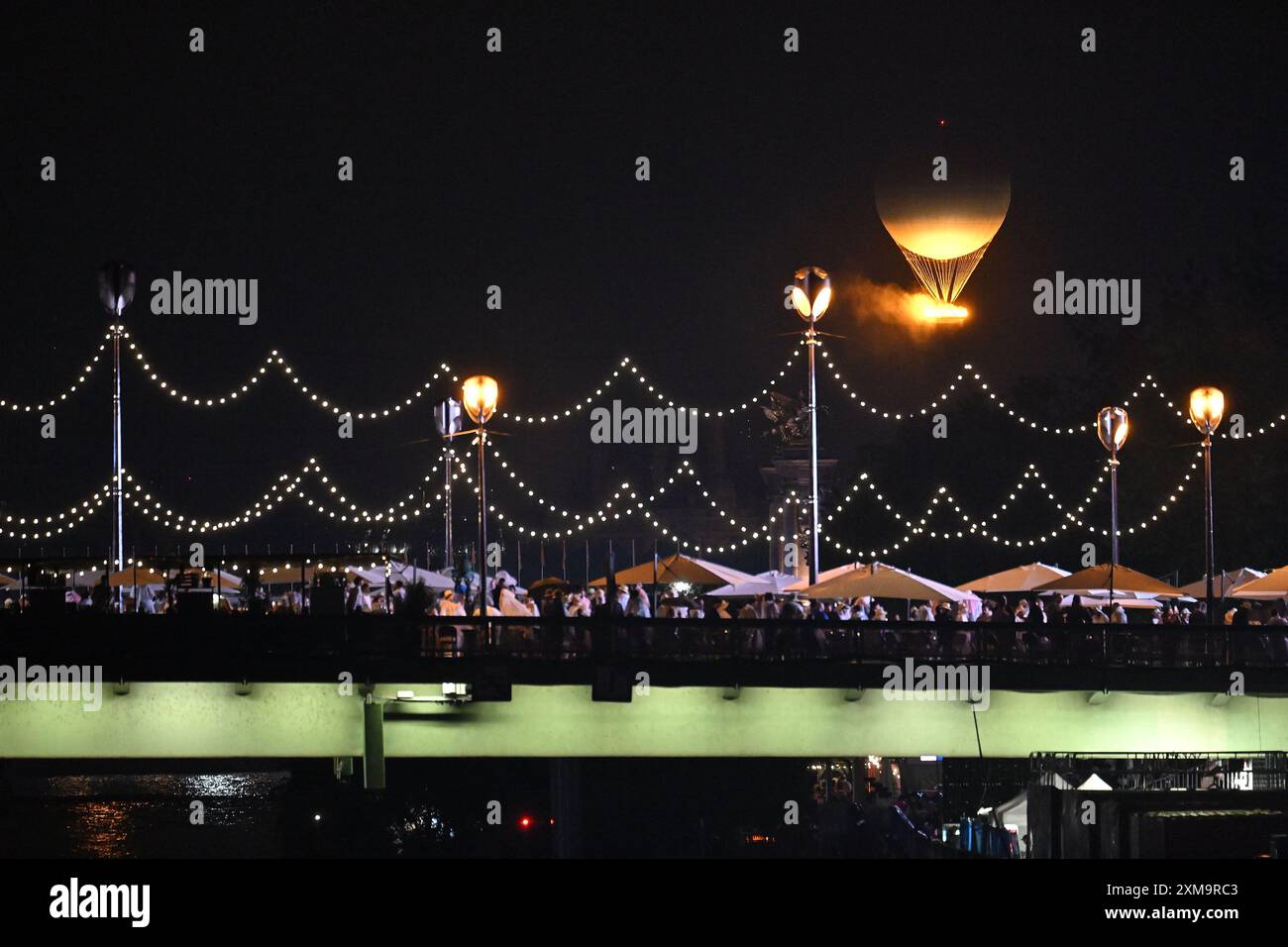 Paris, France. 26th July, 2024. A balloon carrying the lit Olympic ...