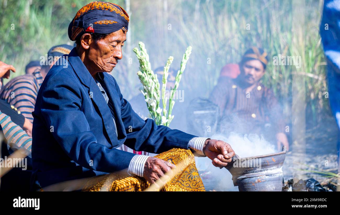 Javanese people pray during the Larungan ceremony on Mount Kelud Stock ...