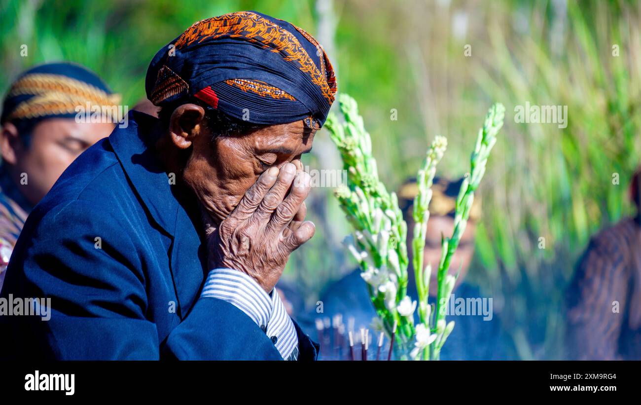 Javanese people pray during the Larungan ceremony on Mount Kelud Stock ...