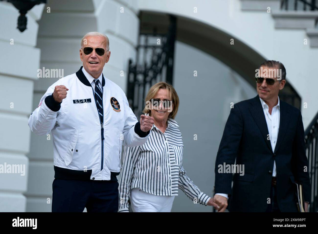 United States President Joe Biden, wearing a Team USA jacket, walks ...