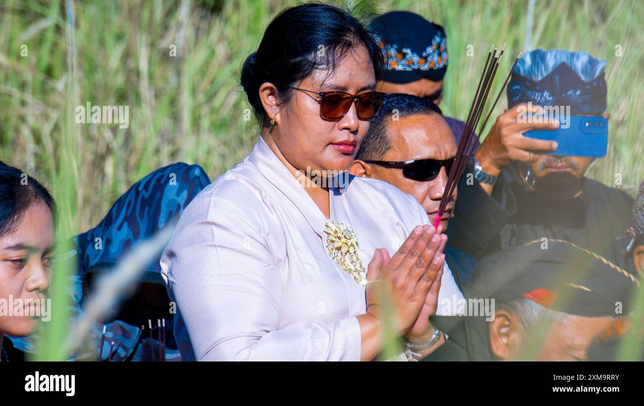 Javanese people pray during the Larungan ceremony on Mount Kelud Stock ...