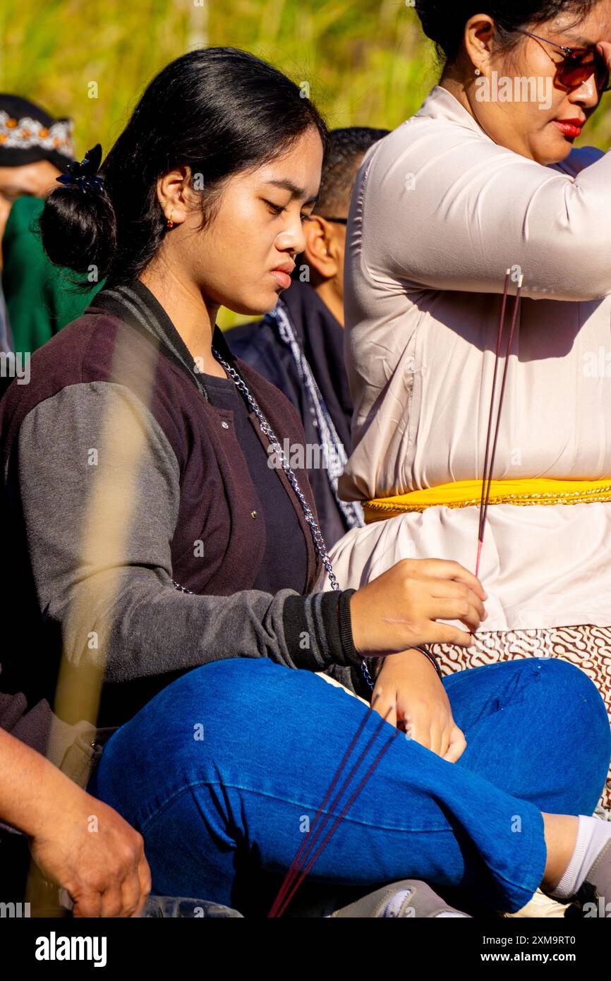 Javanese people pray during the Larungan ceremony on Mount Kelud Stock ...
