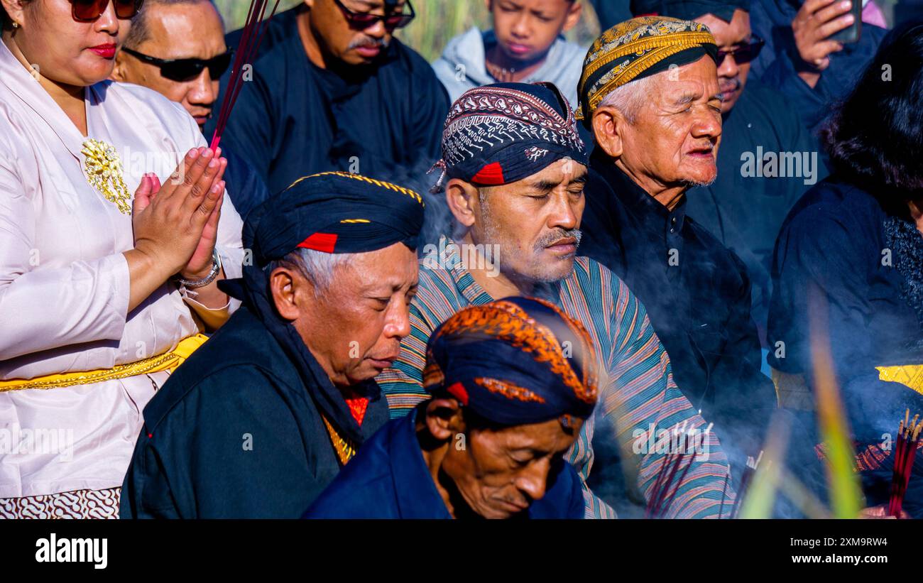 Javanese people pray during the Larungan ceremony on Mount Kelud Stock ...