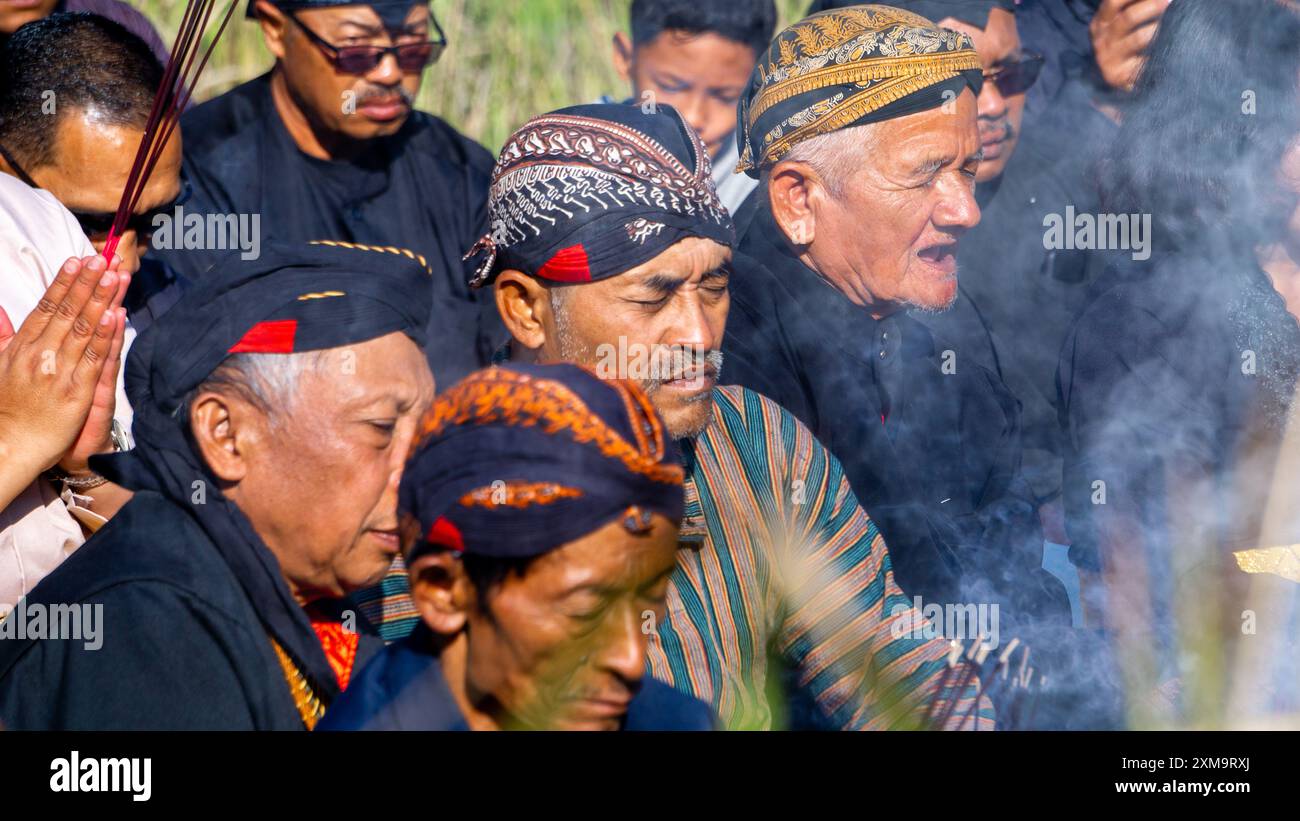 Javanese people pray during the Larungan ceremony on Mount Kelud Stock ...