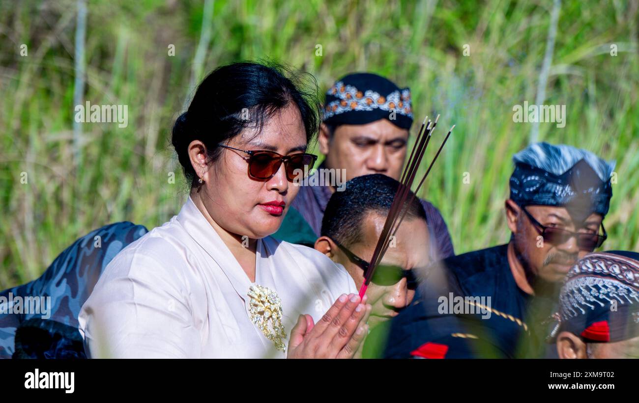 Javanese people pray during the Larungan ceremony on Mount Kelud Stock ...
