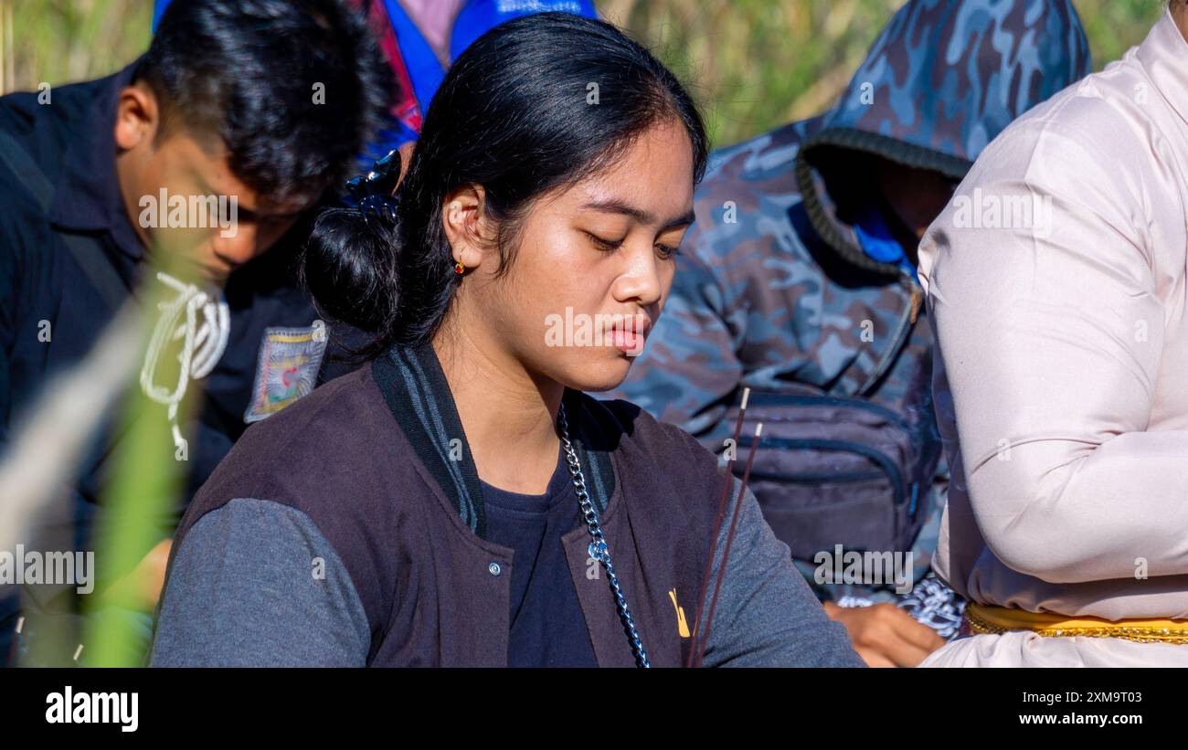Javanese people pray during the Larungan ceremony on Mount Kelud Stock ...