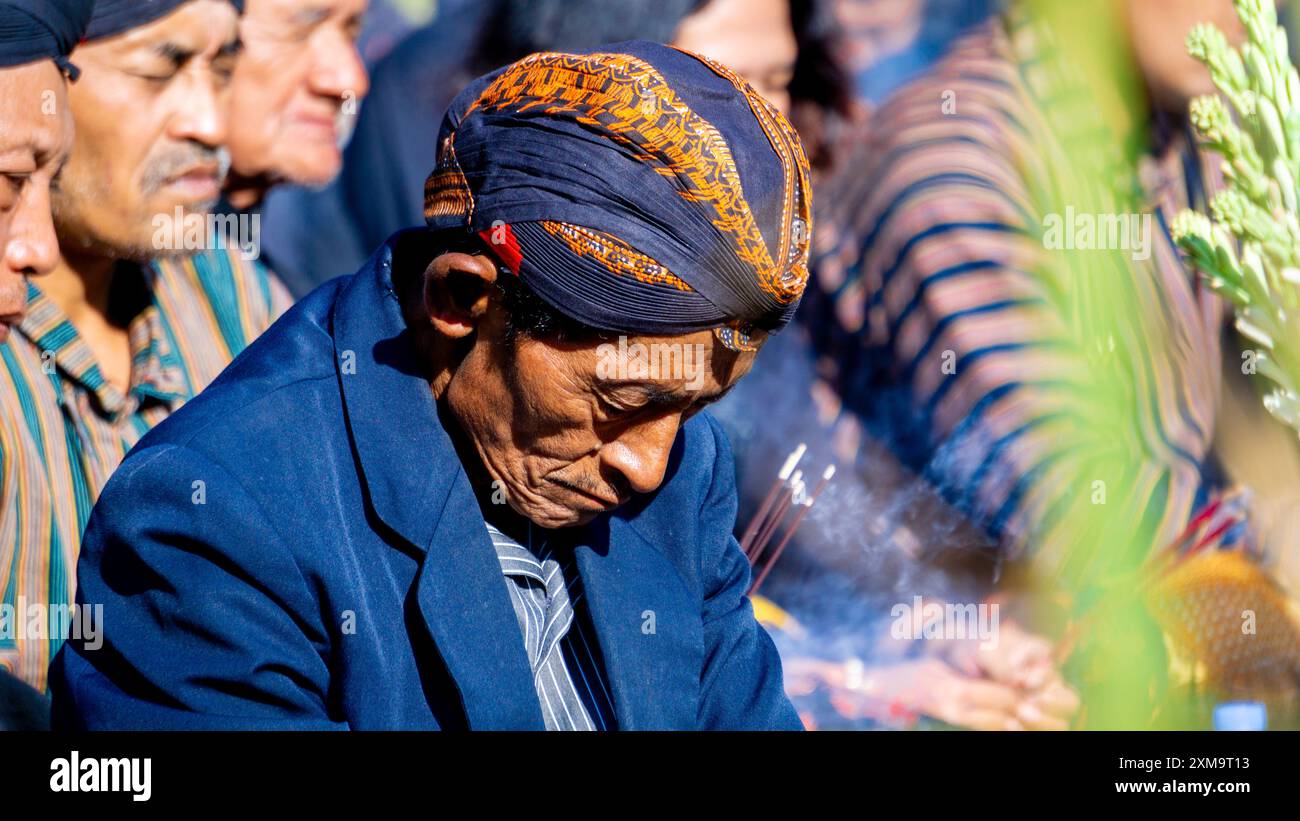 Javanese people pray during the Larungan ceremony on Mount Kelud Stock ...