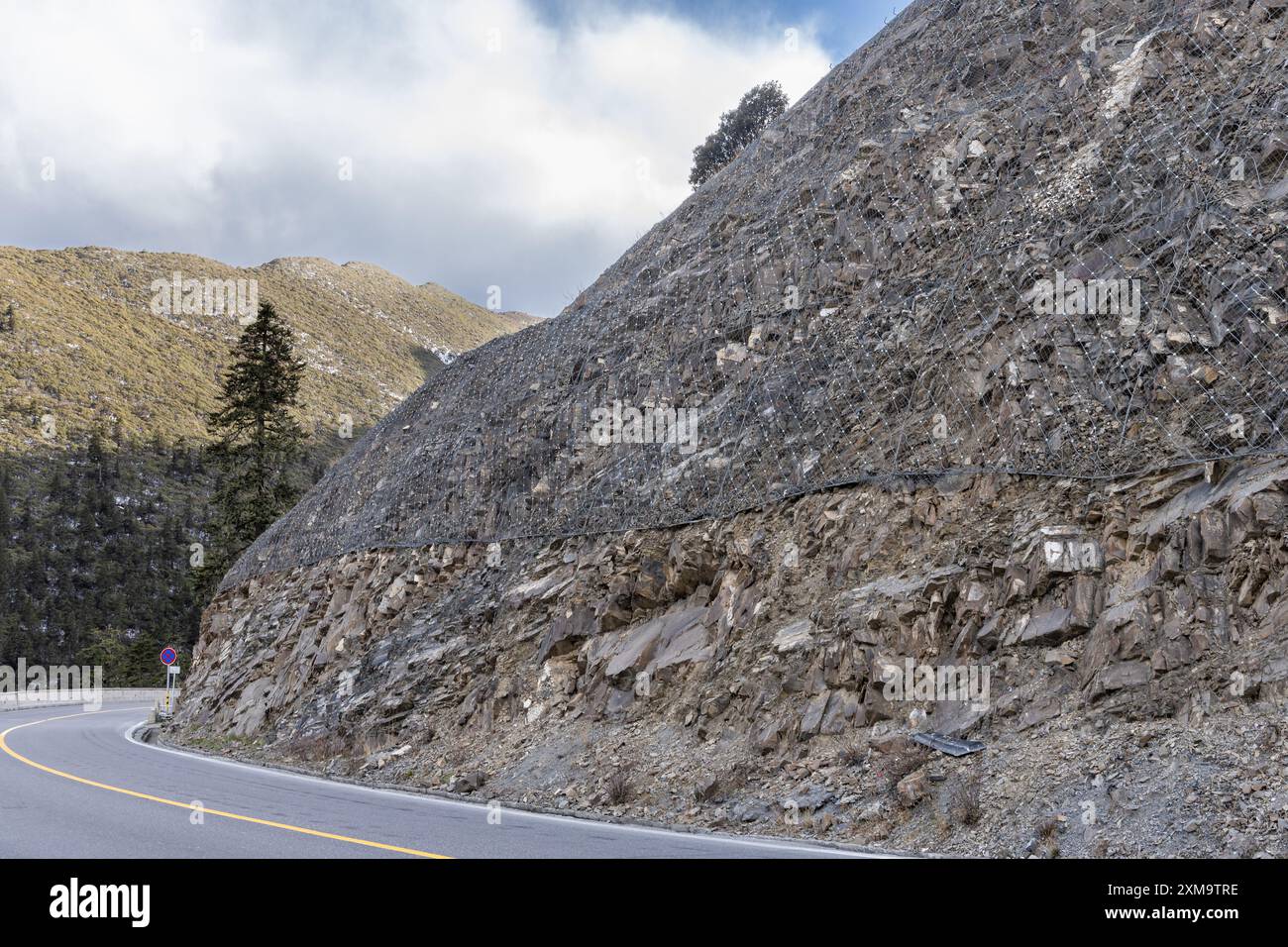 Close-up on wire mesh grid installed on slope to stabalize the soil and ...
