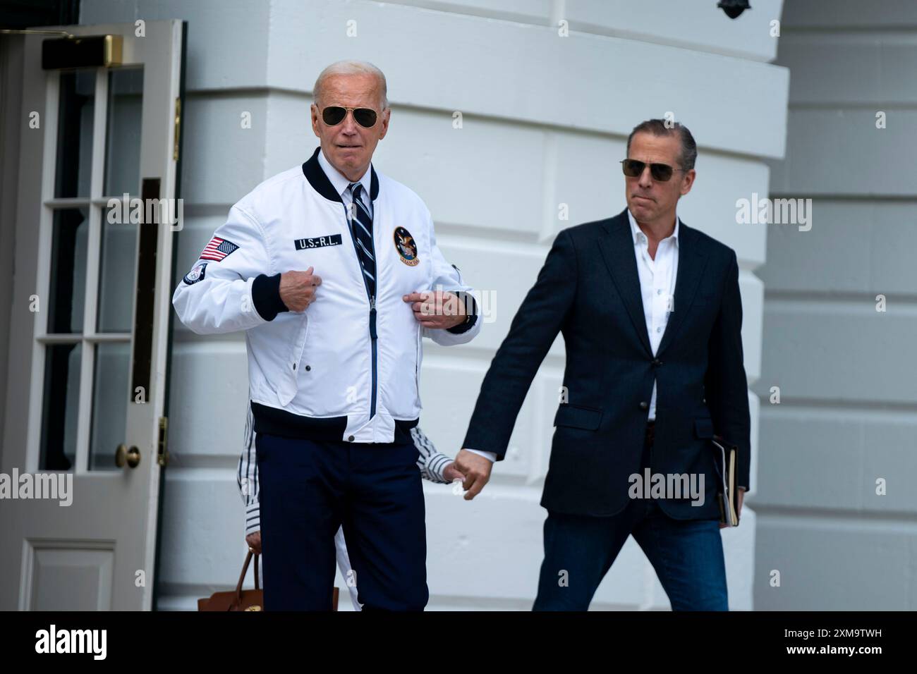 United States President Joe Biden gestures to his Team USA jacket as ...