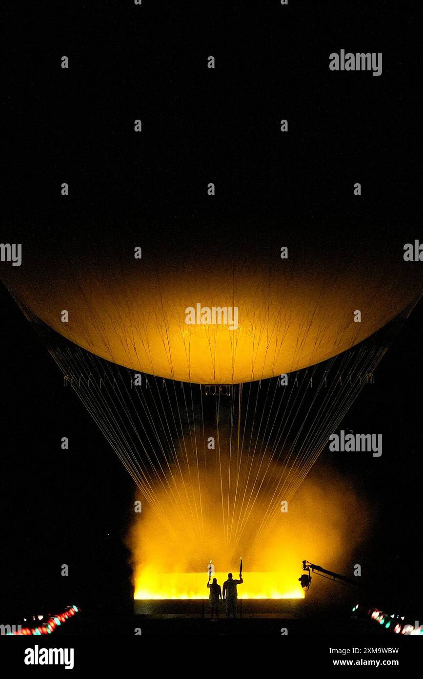 Teddy Riner and Marie-Jose Perec watch as the cauldron rises in a ...