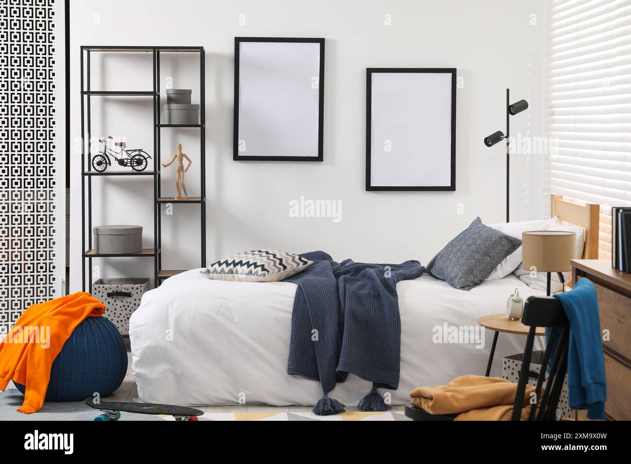 Teen's room interior with modern furniture and empty frames on wall ...