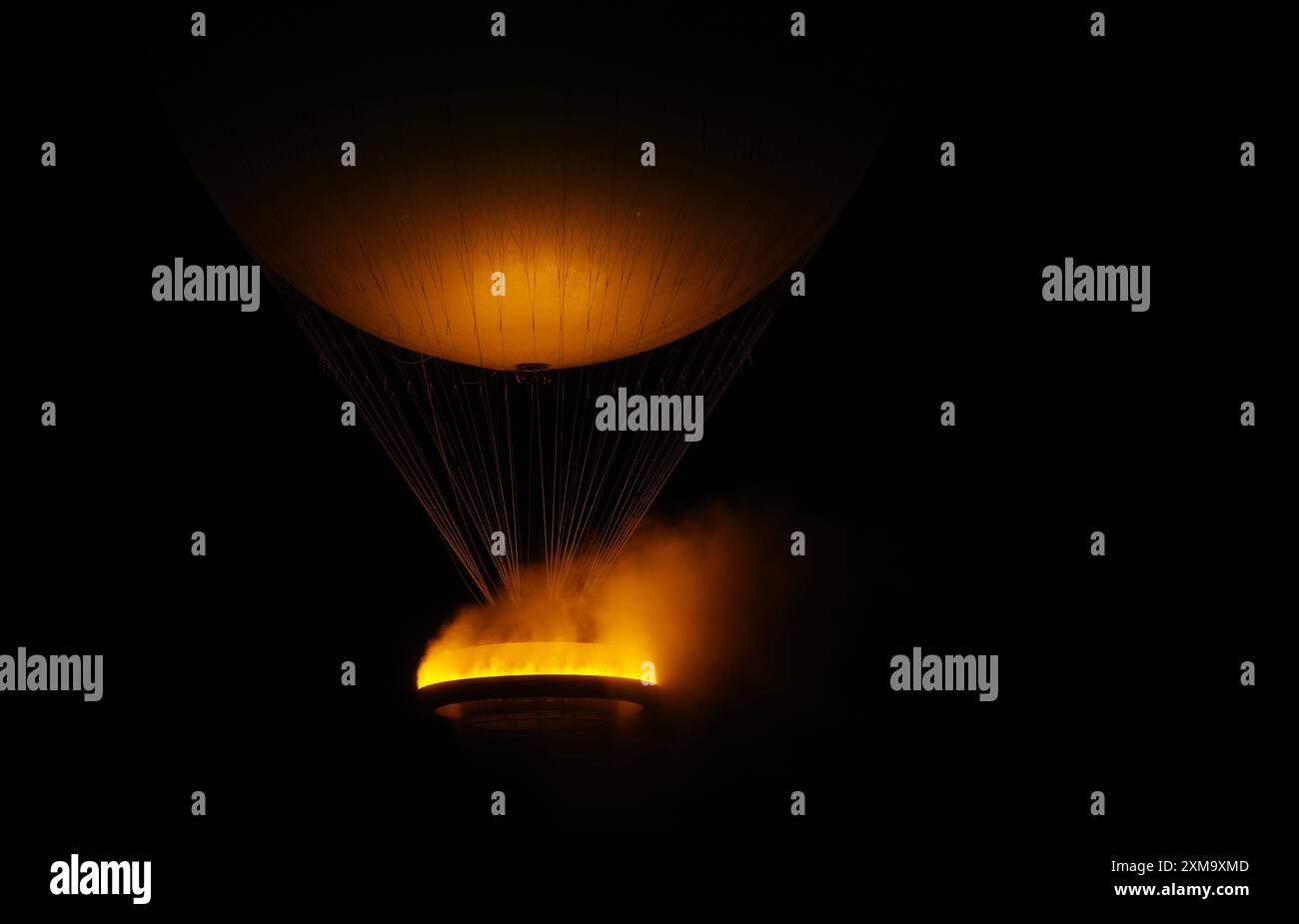 Paris, France. 26th July, 2024. A balloon carrying the lit Olympic ...