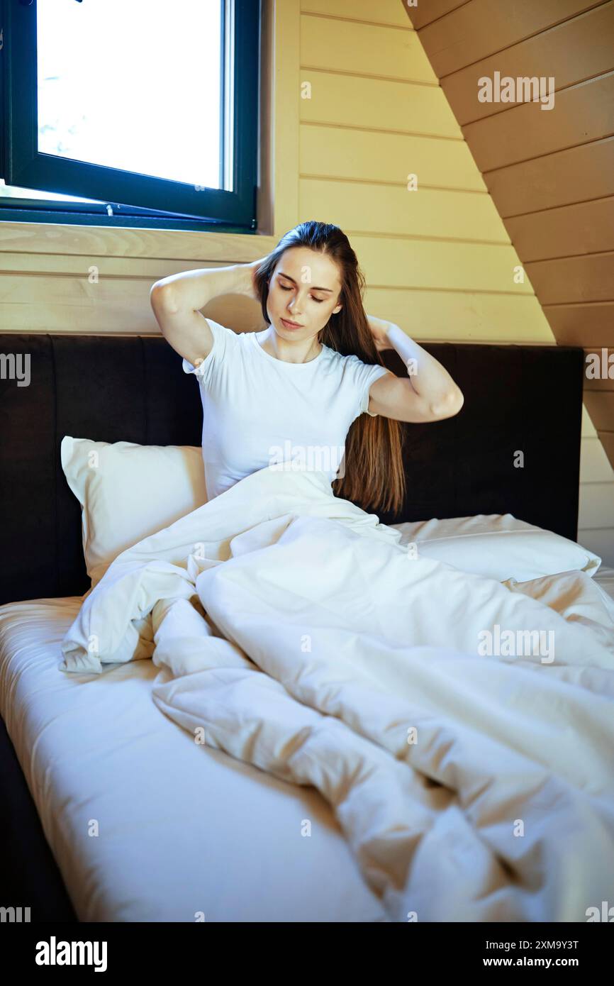 Sleepy woman wake up in the morning in log cabin Stock Photo - Alamy