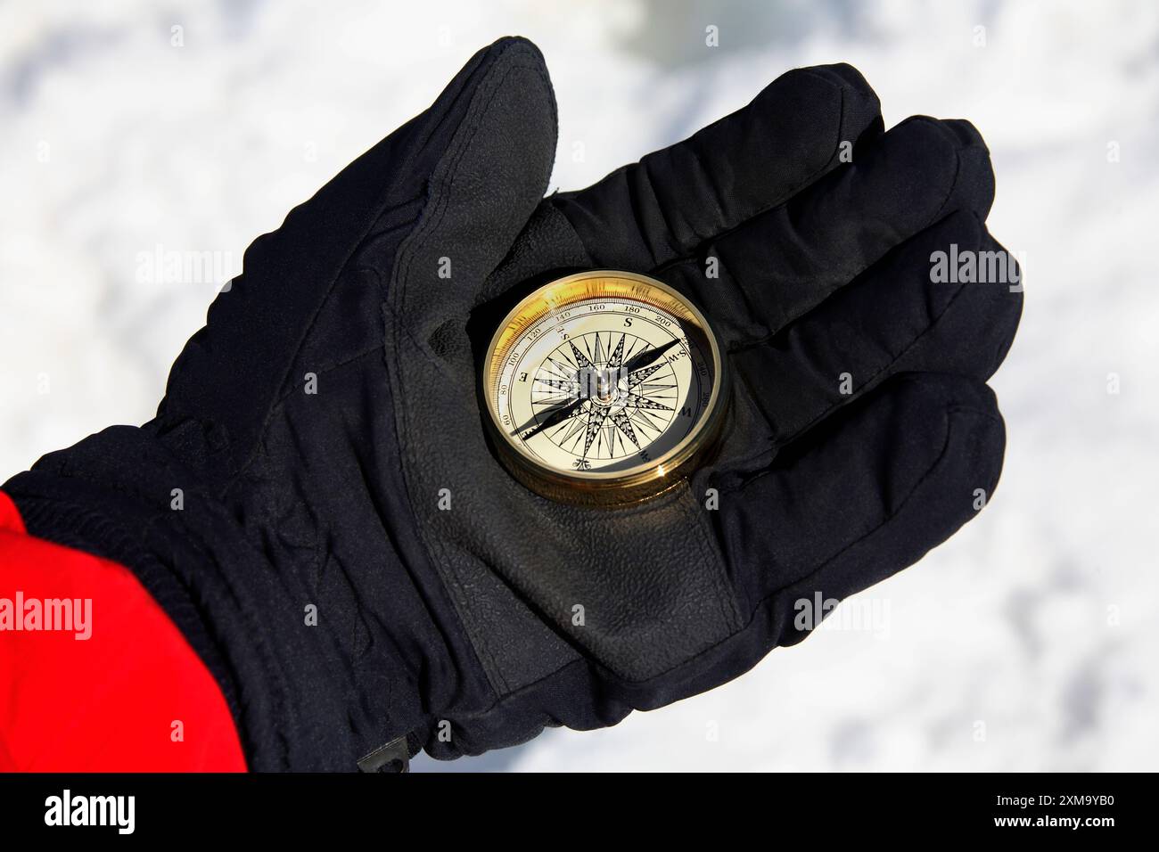 Compass in gloved hand Stock Photo - Alamy