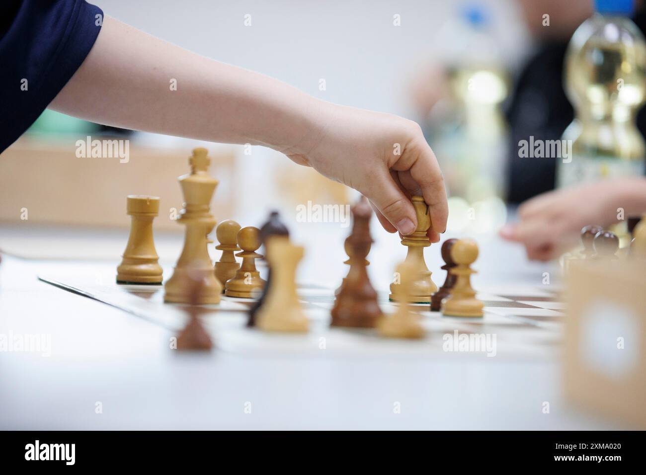 Hand moves a chess piece, strategic thinking and concentration in the ...