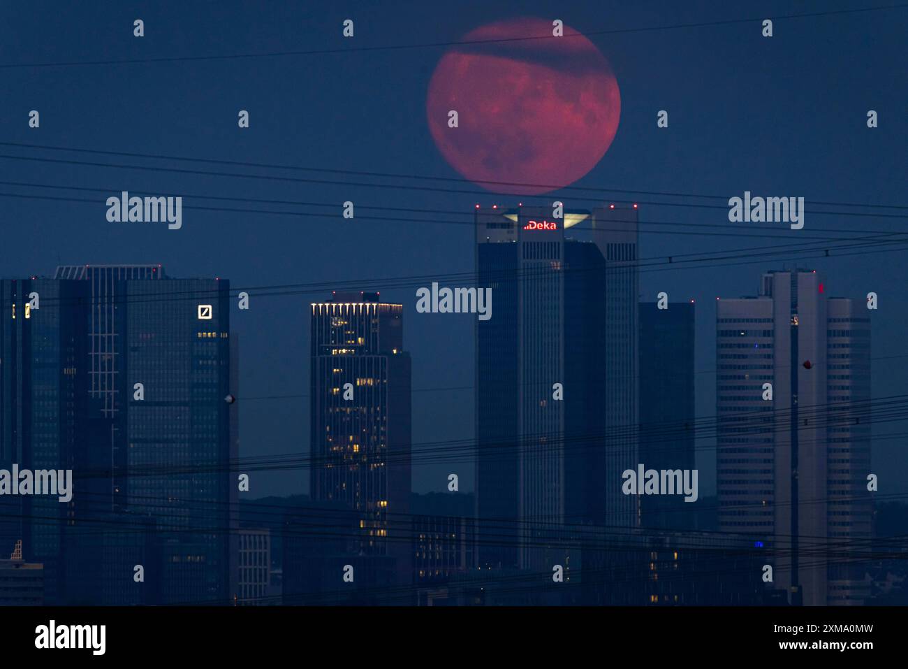 The red full moon passes over Frankfurt's banking skyline. Because of ...