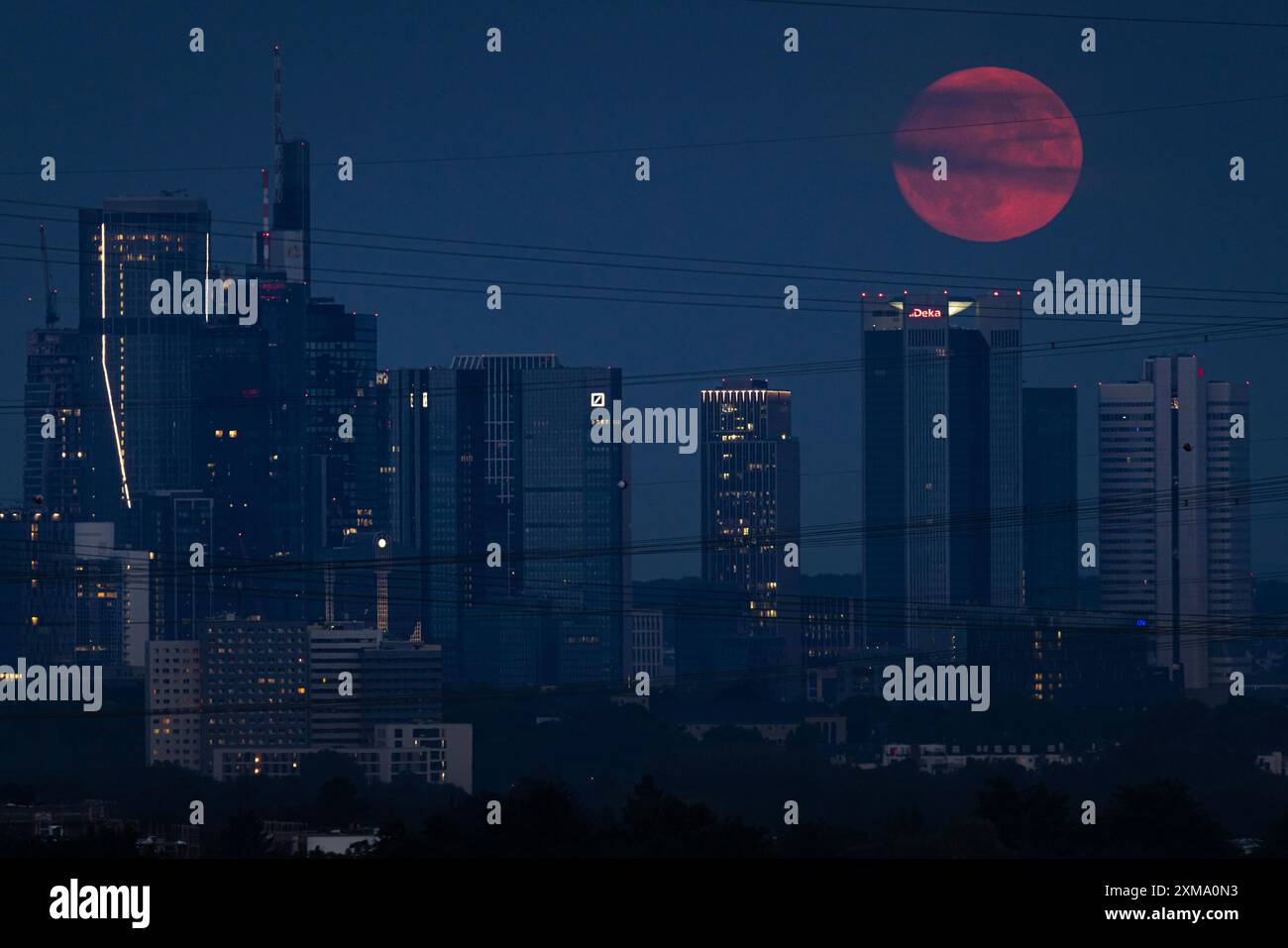 The red full moon passes over Frankfurt's banking skyline. Because of ...