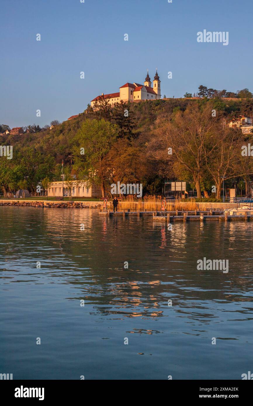 Sunrise on the shore and harbour of a lake in summer. Colourful sky ...