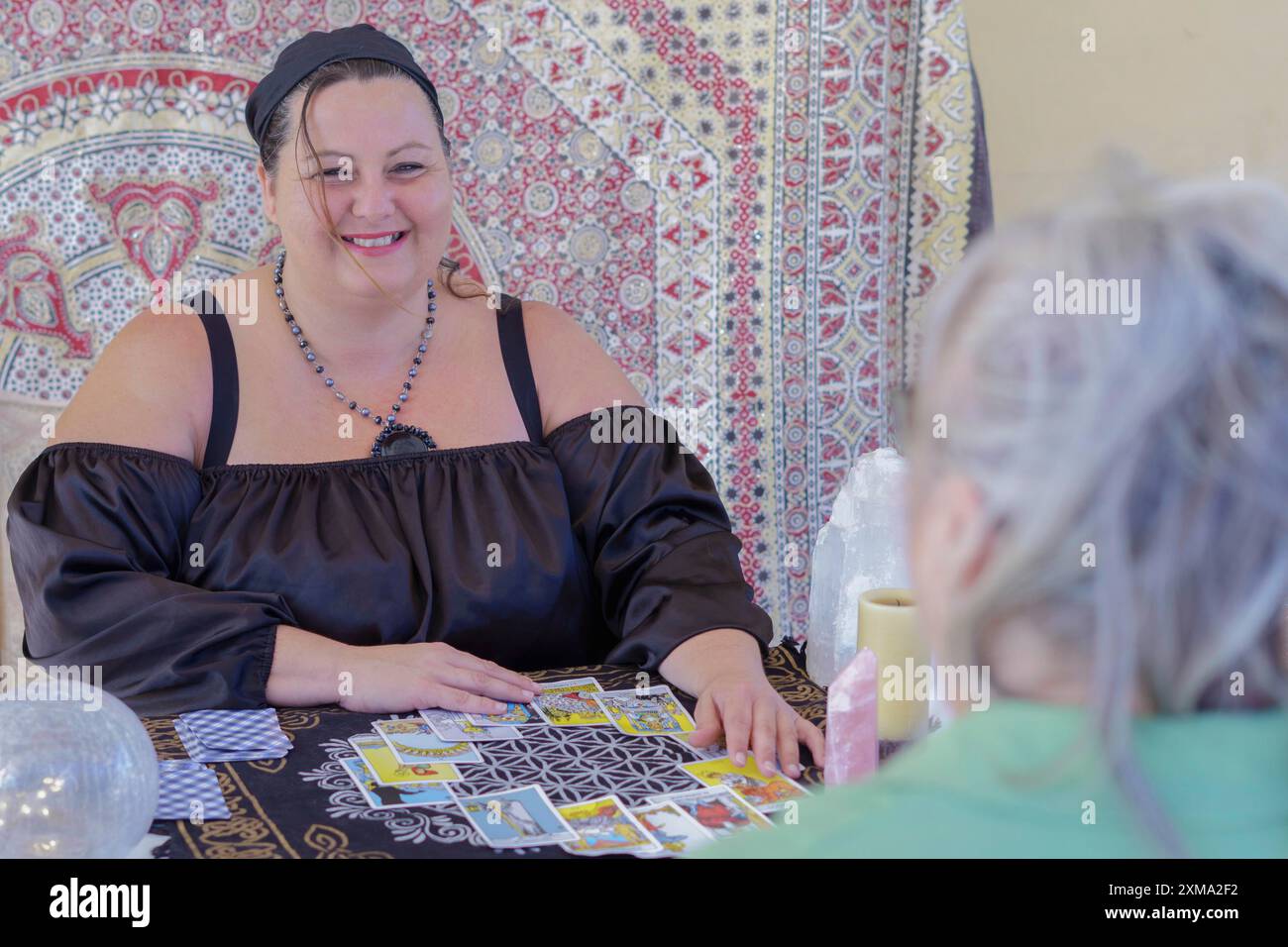 Gypsy fortune teller dressed in black casting tarot cards divining the ...
