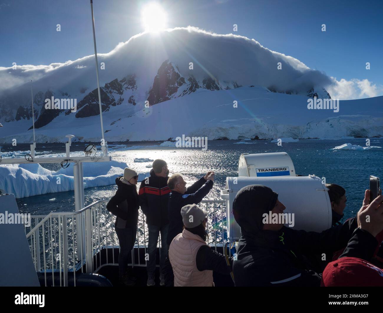 Tourists on board an Antarctic cruise ship taking photographs of the ...