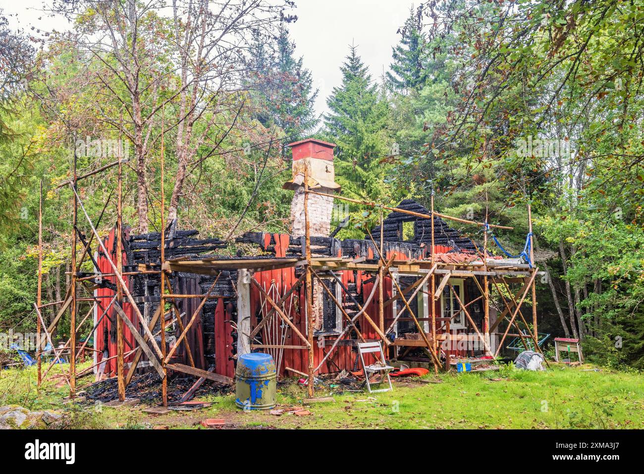 Wooden cottage that has burned down in the woodland, Sweden Stock Photo ...