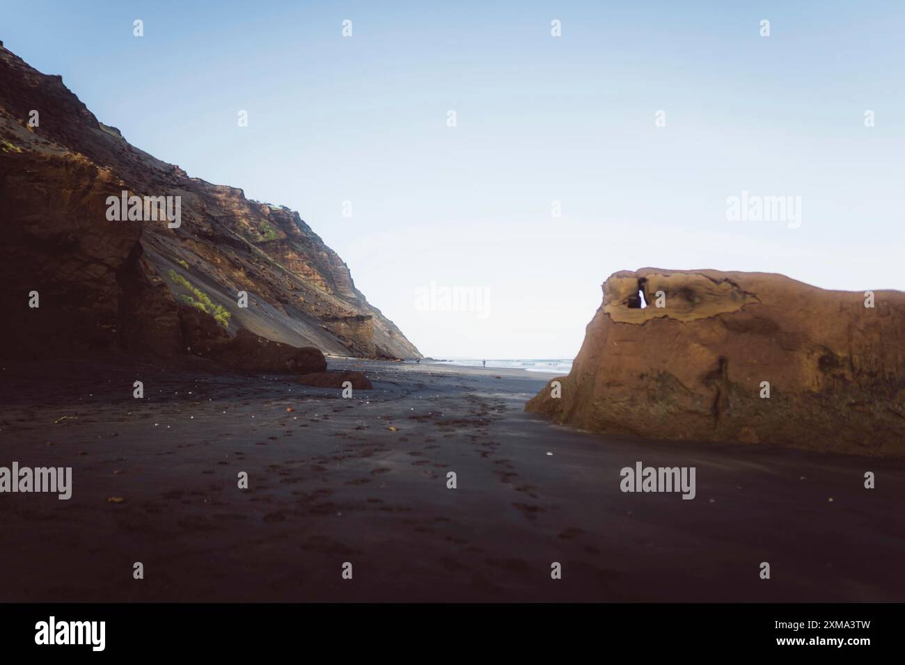 Coastal landscape with large rocks and a view of the ocean water and ...