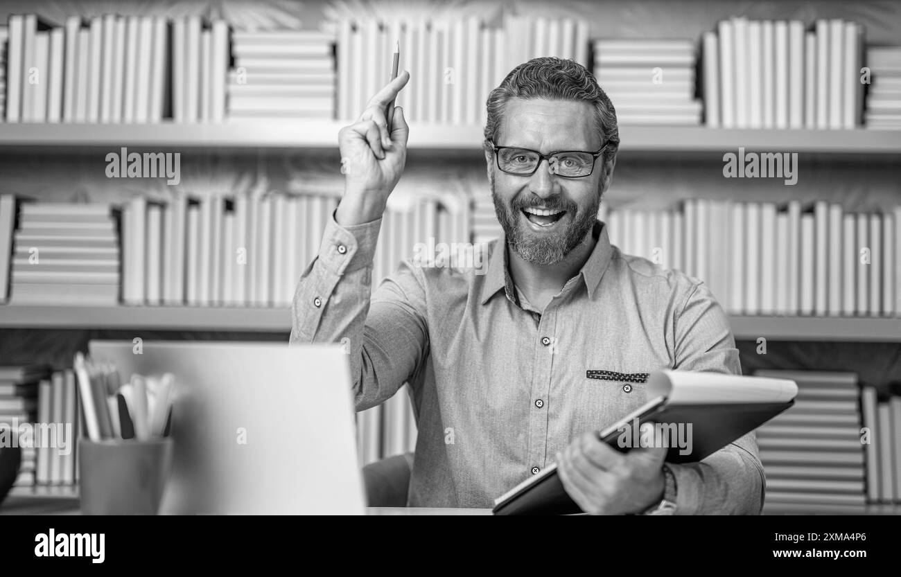 Teacher in classroom. school tutor with book in classroom. Man on ...