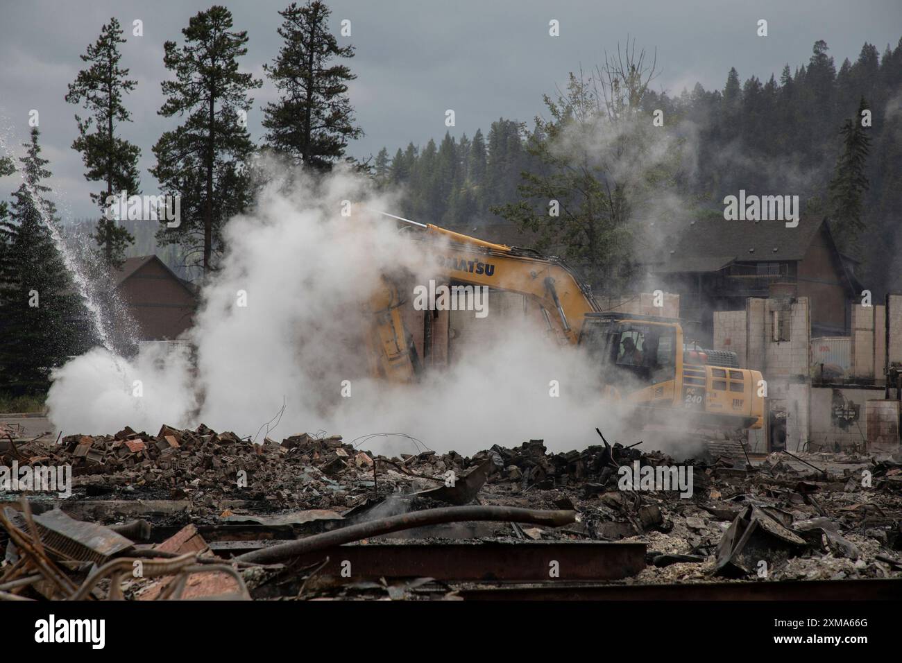 Fire crews work to put out hotspots in the Maligne Lodge in Jasper ...