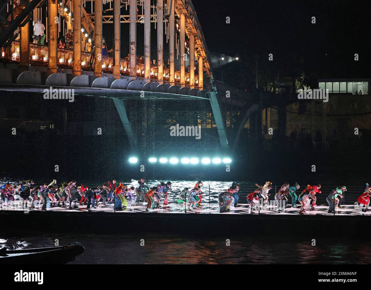 Performers sail along the River Seine on a boat during the opening ...