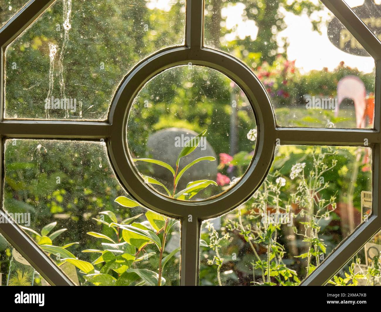 View through a round window onto a sunny garden, borken, westphalia ...