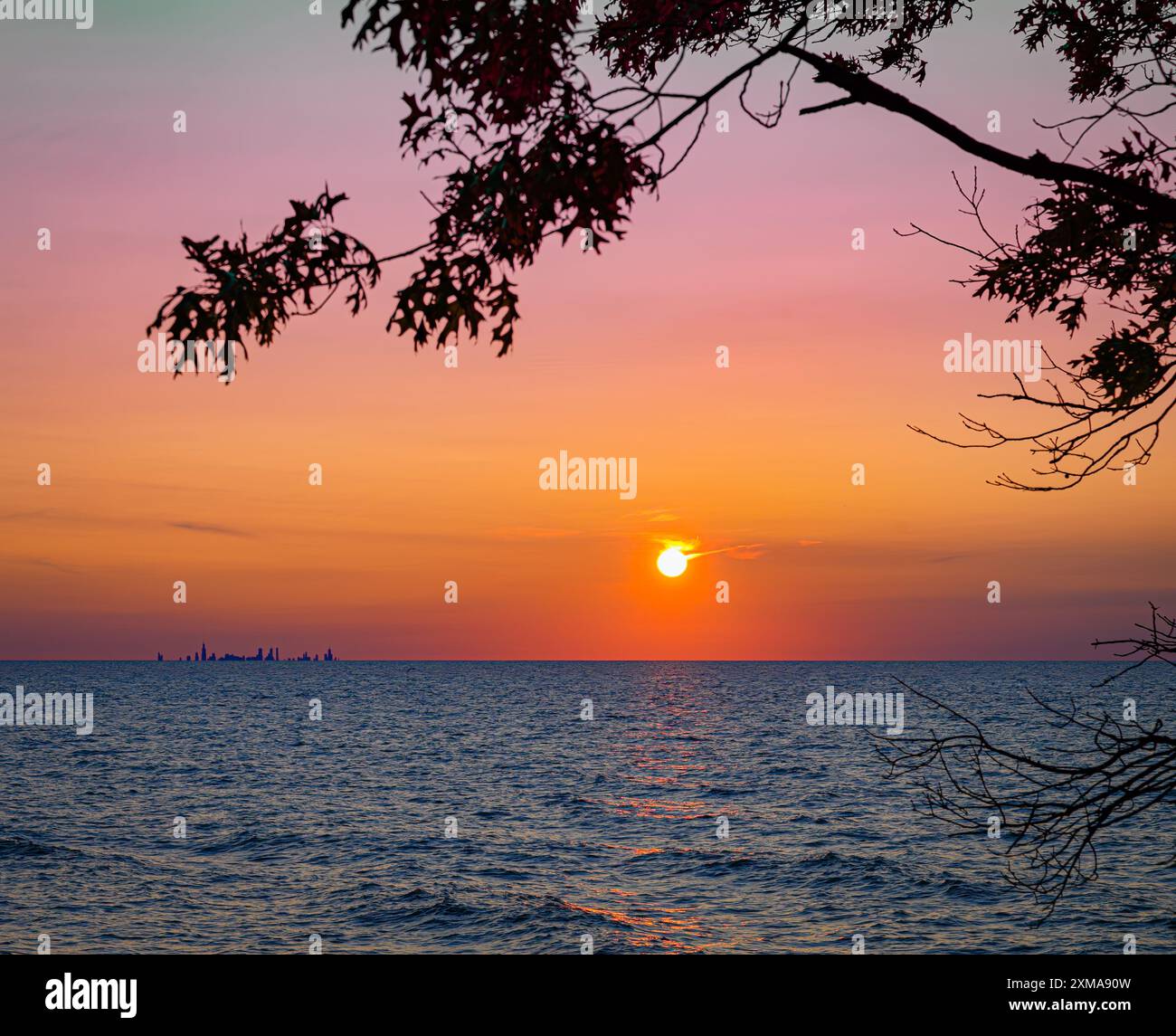 Lake Michigan sunset with outline of Chicago downtown buildings on ...